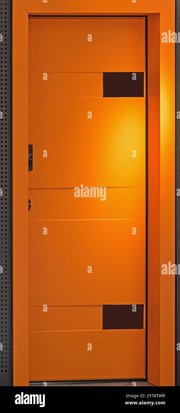 Closed orange color modern entrance door from inside Stock Photo - Alamy