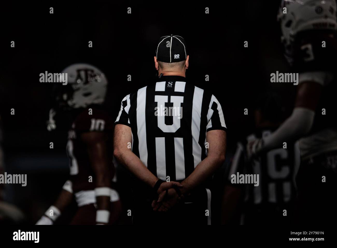 ARLINGTON, TX - SEPTEMBER 28: An referee stands in a beam of light ...