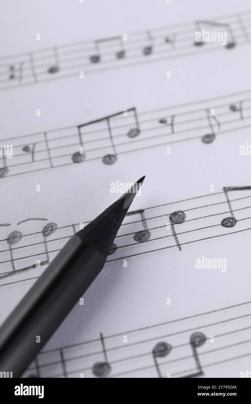 Sheet with musical notes and pencil, closeup view Stock Photo - Alamy
