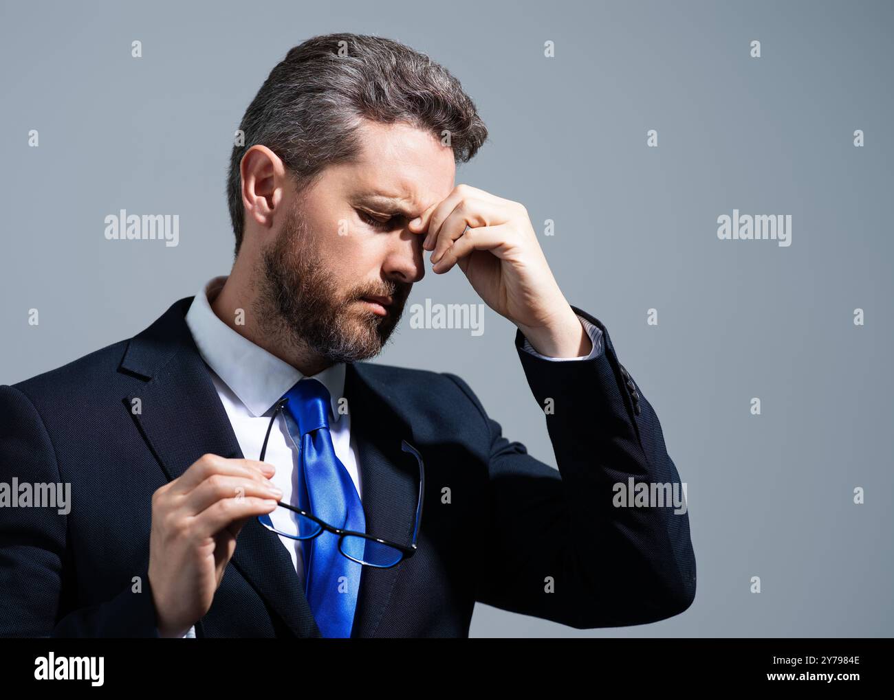 Headache, tiredness and stress. Business man in suit is tired got ...