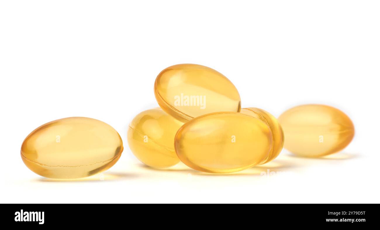 close-up macro view of fish oil capsules or pills isolated white ...