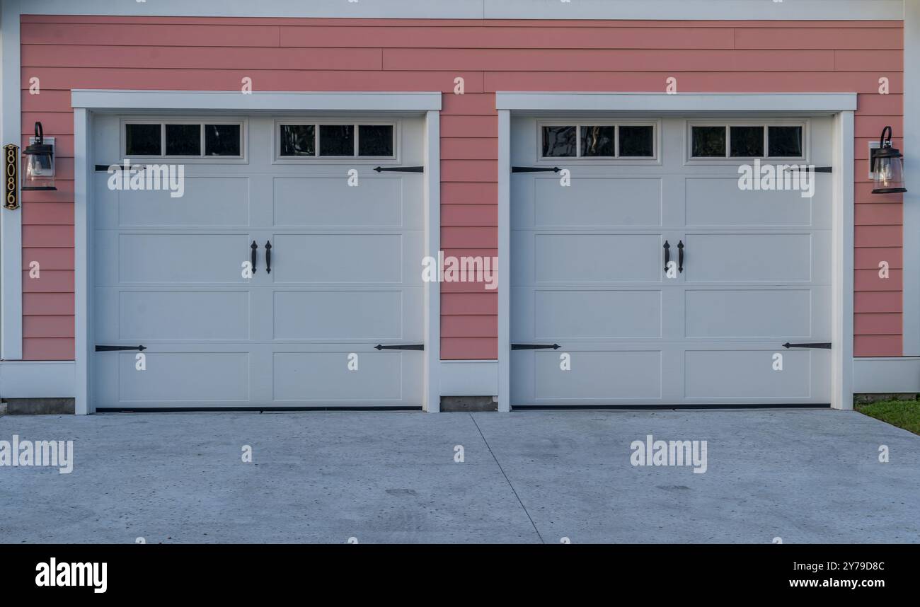 White electronic garage doors transom light windows on a double garage ...