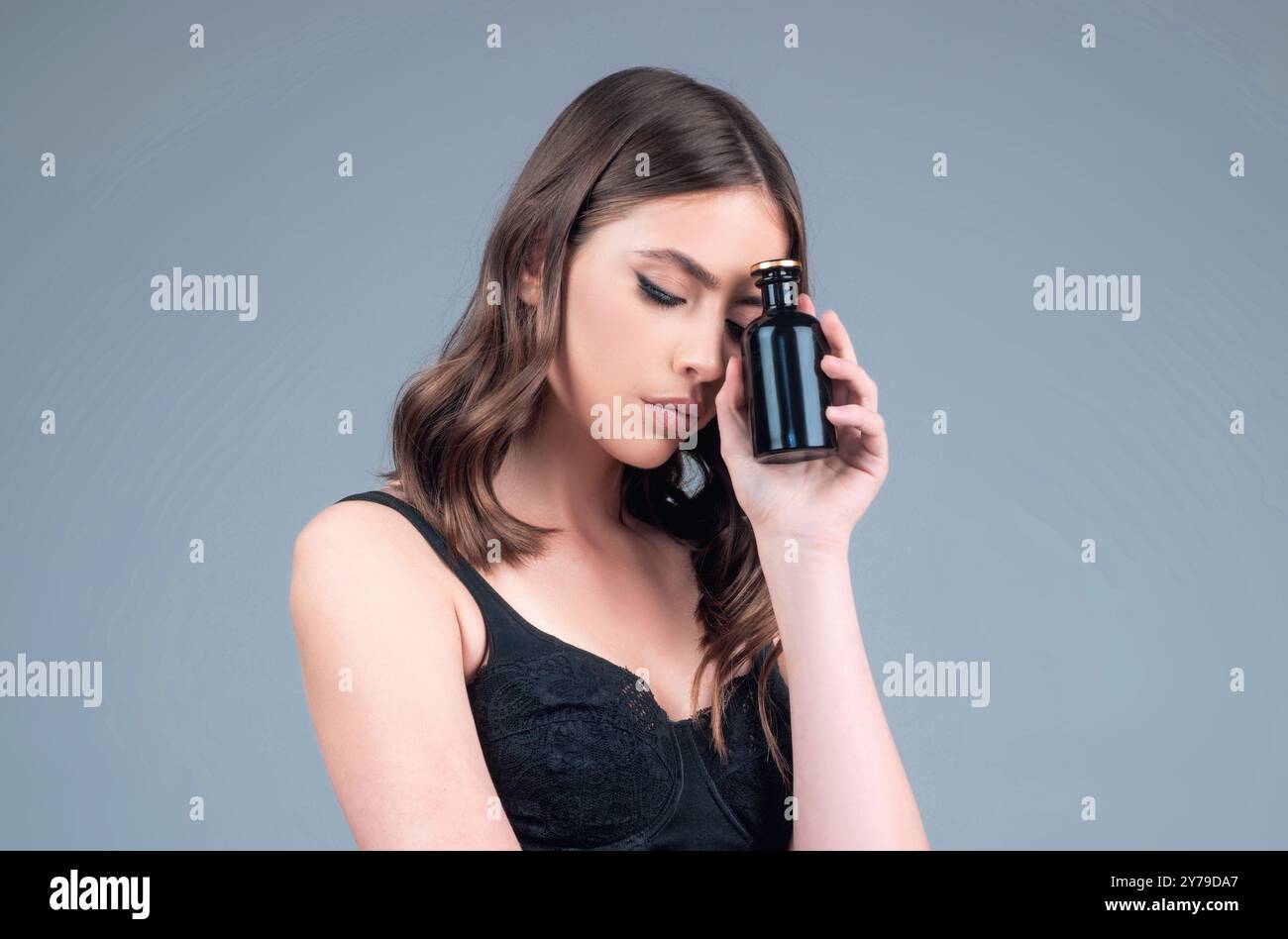 Perfume bottle. Woman with spray aroma perfume. Woman holding a ...
