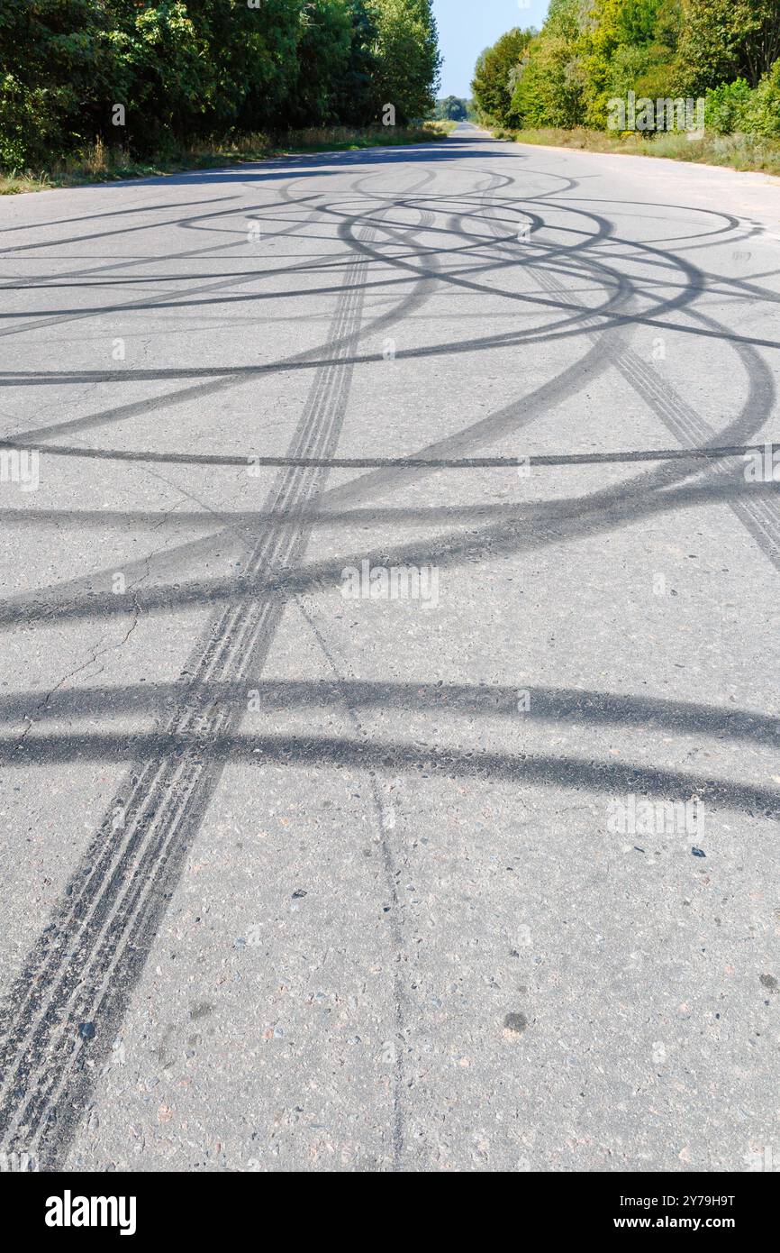 Skid marks on the road surface. Circular tire tracks left by drivers ...