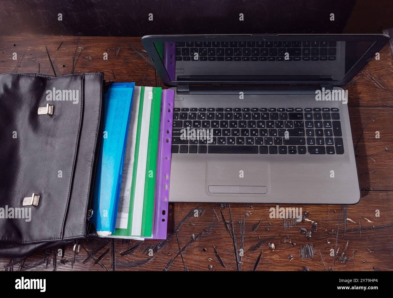 Open laptop and work briefcase. Work briefcase with notebooks and ...