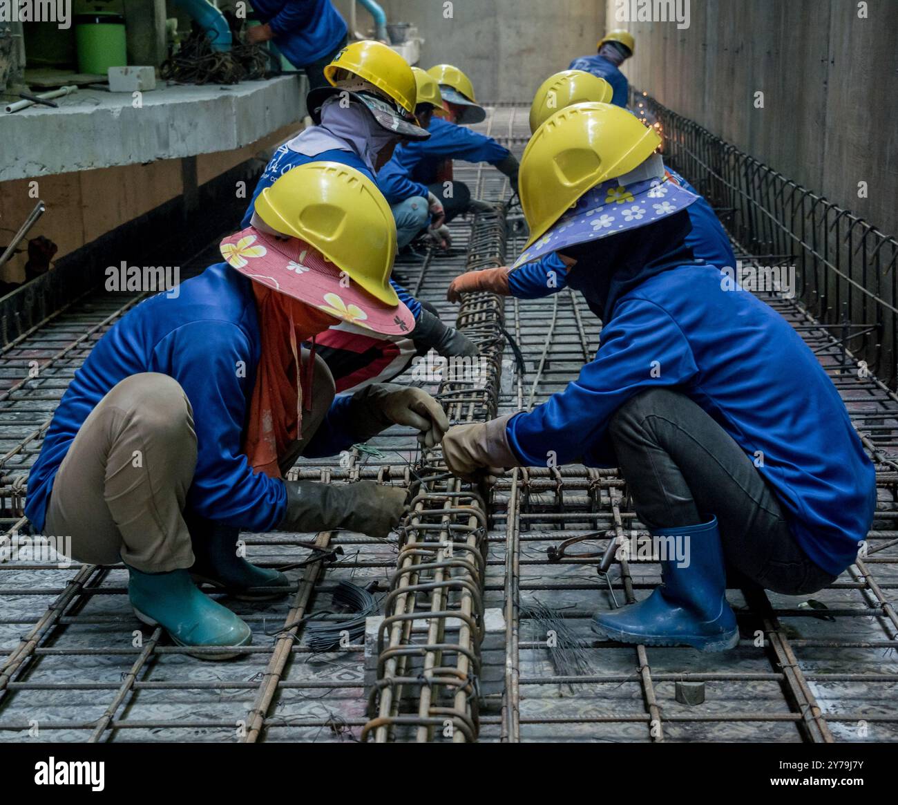 A group of builders is busy constructing a metal structure Stock Photo ...