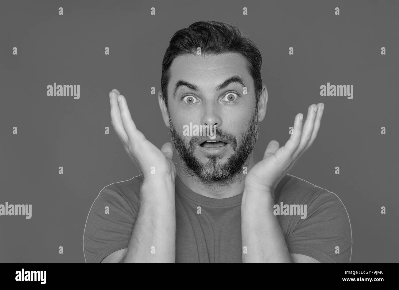 Handsome surprised man over isolated studio background afraid and ...