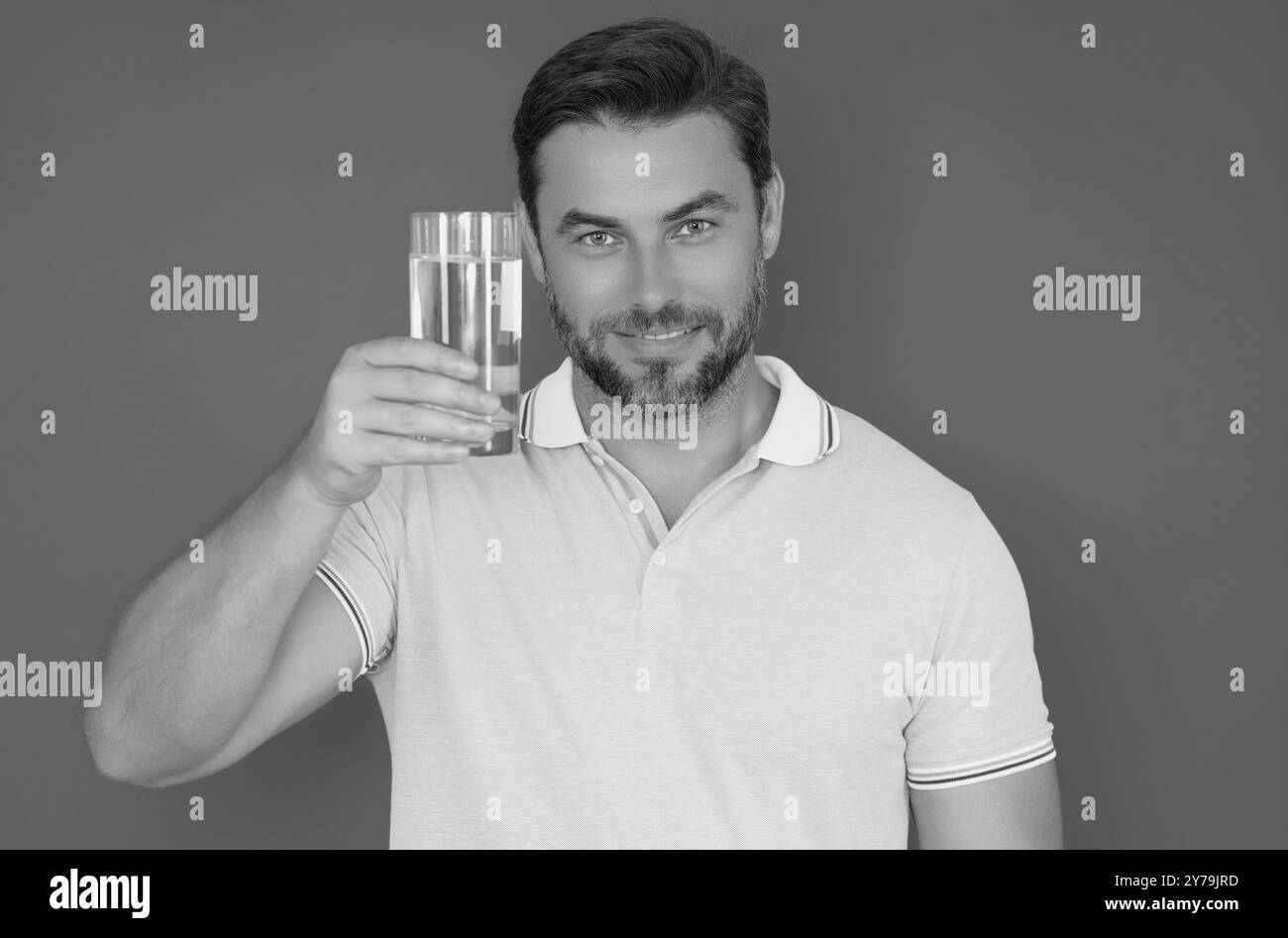 Man drinking water isolated on studio background. Portrait of man with ...