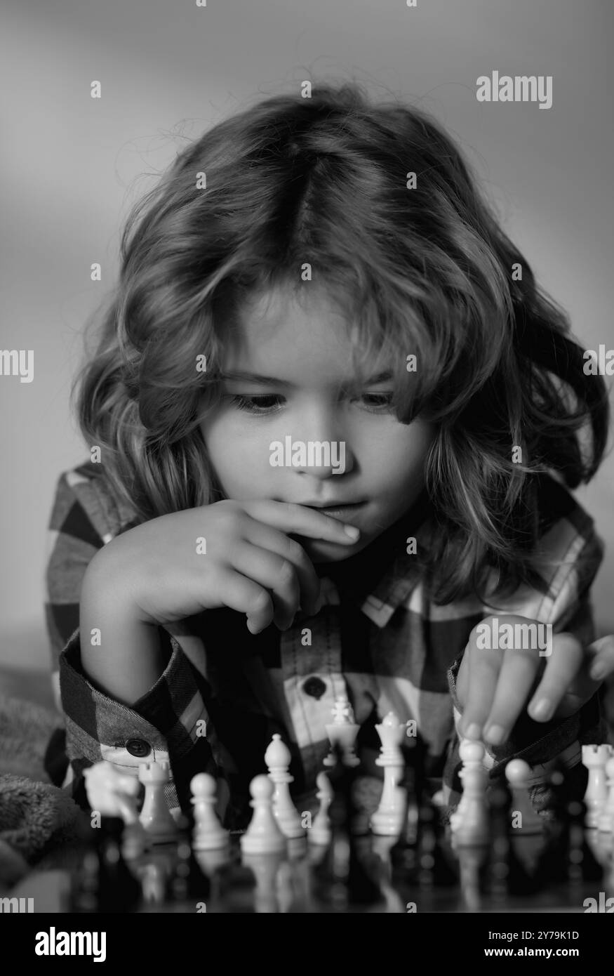 Chess game with children at home. Little kid play chess. Thinking child ... Chess game with children at home. Little kid play chess. Thinking child ...