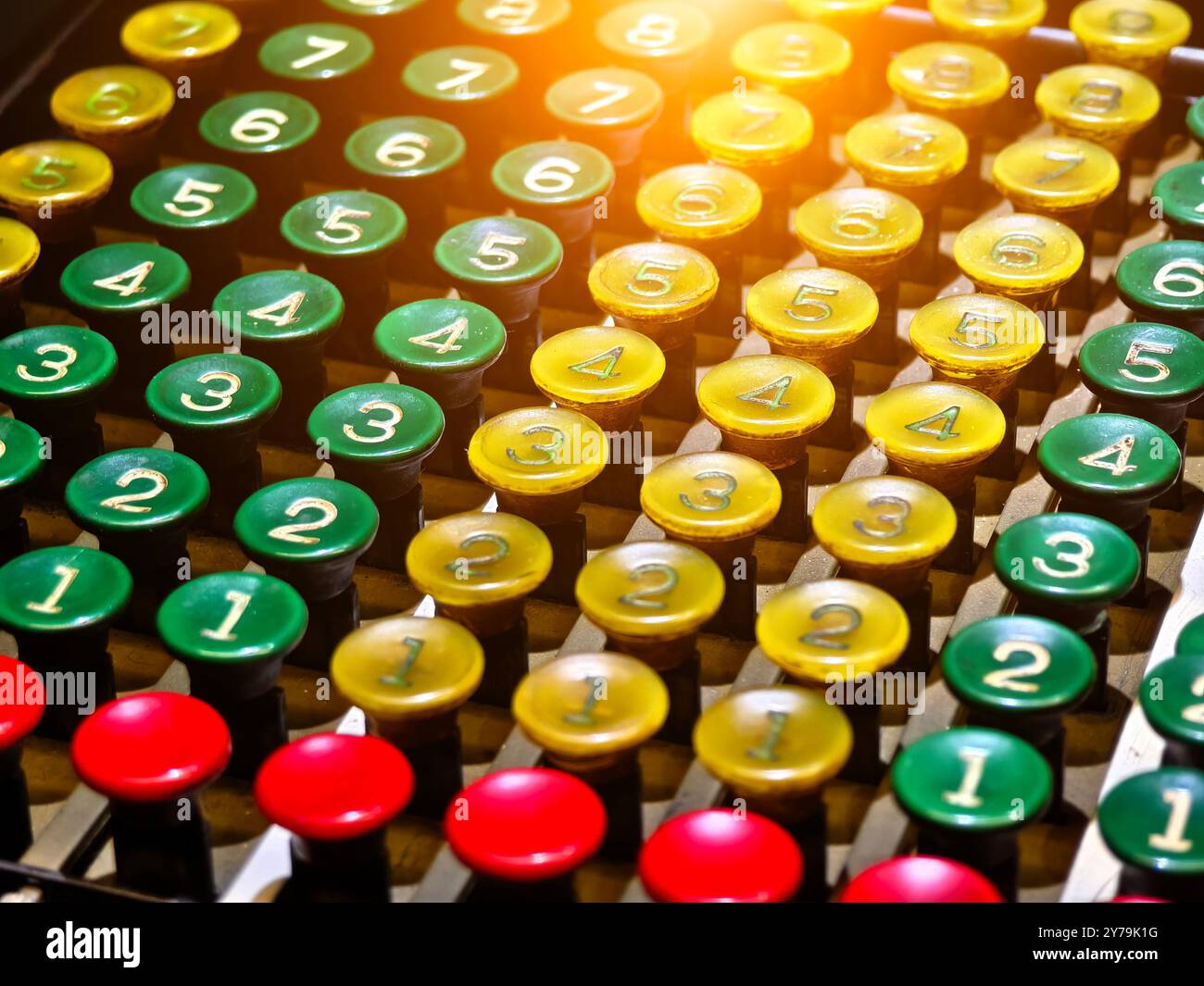 An old fashioned adding machine features a drawer located underneath it ...