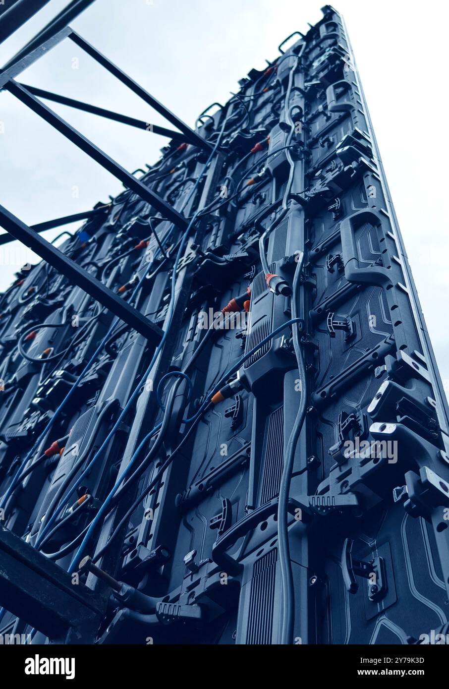 A bunch of electrical wires and connectors are hanging down from a led ...