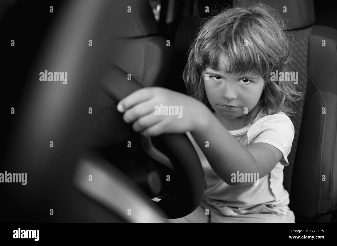 Little Driver. Cute little boy pretending to drive. Kid in car with his ...