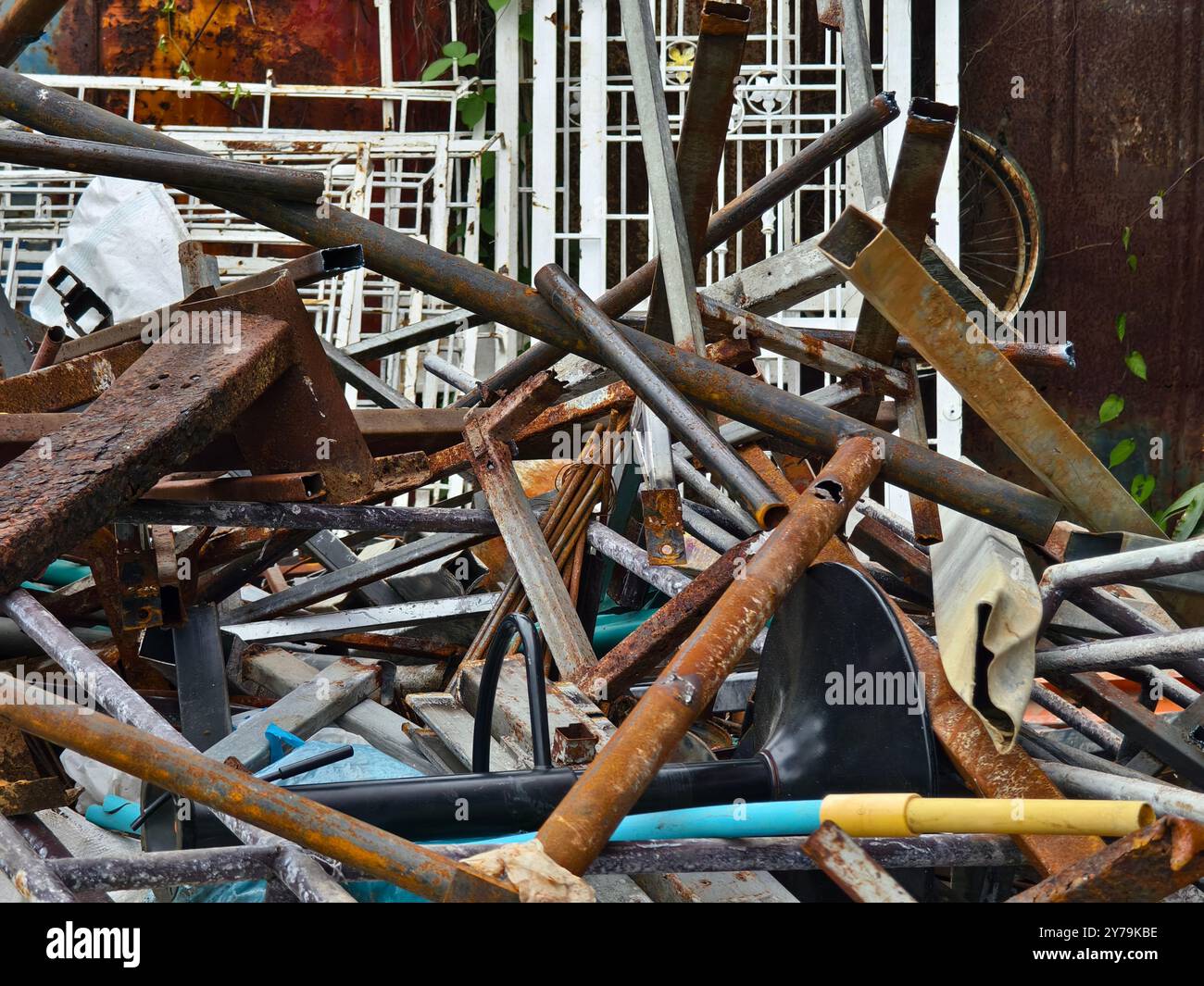 A pile of garbage with a bucket, rope, bottles, and other items at a ...
