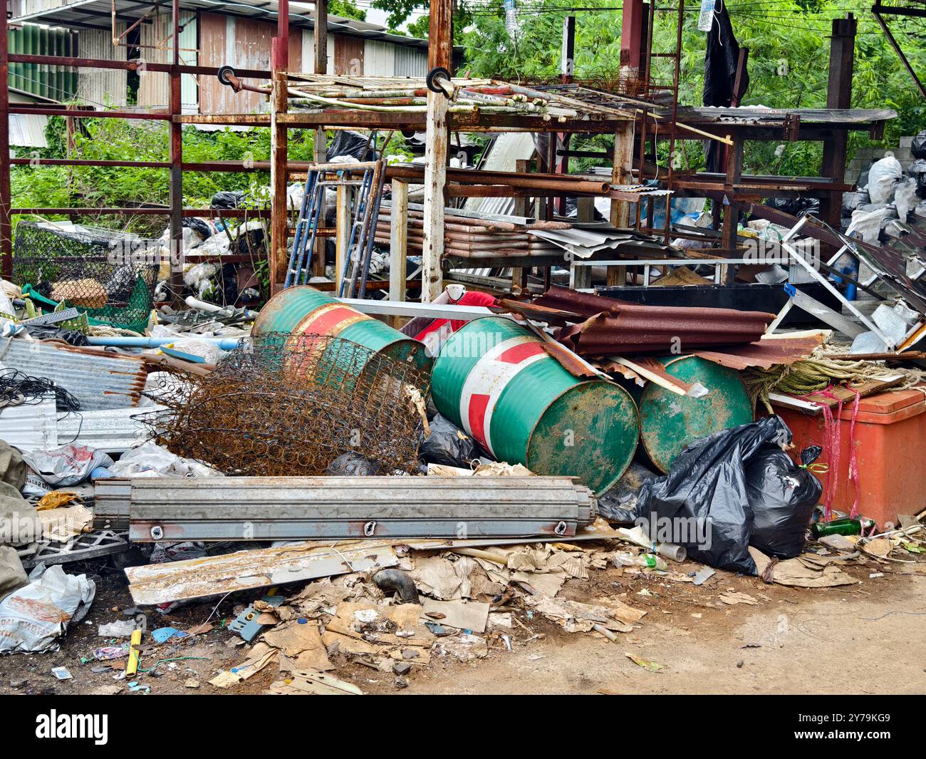 A pile of garbage with a bucket, rope, bottles, and other items at a ...