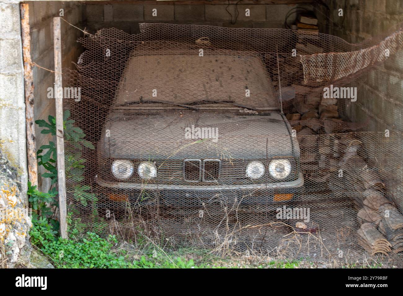 vintage BMW motor car abandoned in a carport rusting and corroding, old car in garage ...