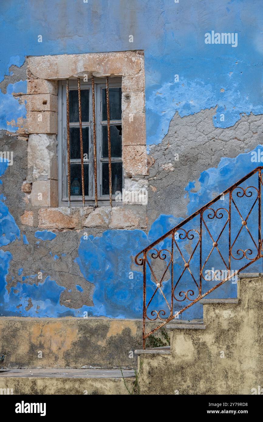typically, Greek distressed and weather beaten blue painted wall with ...