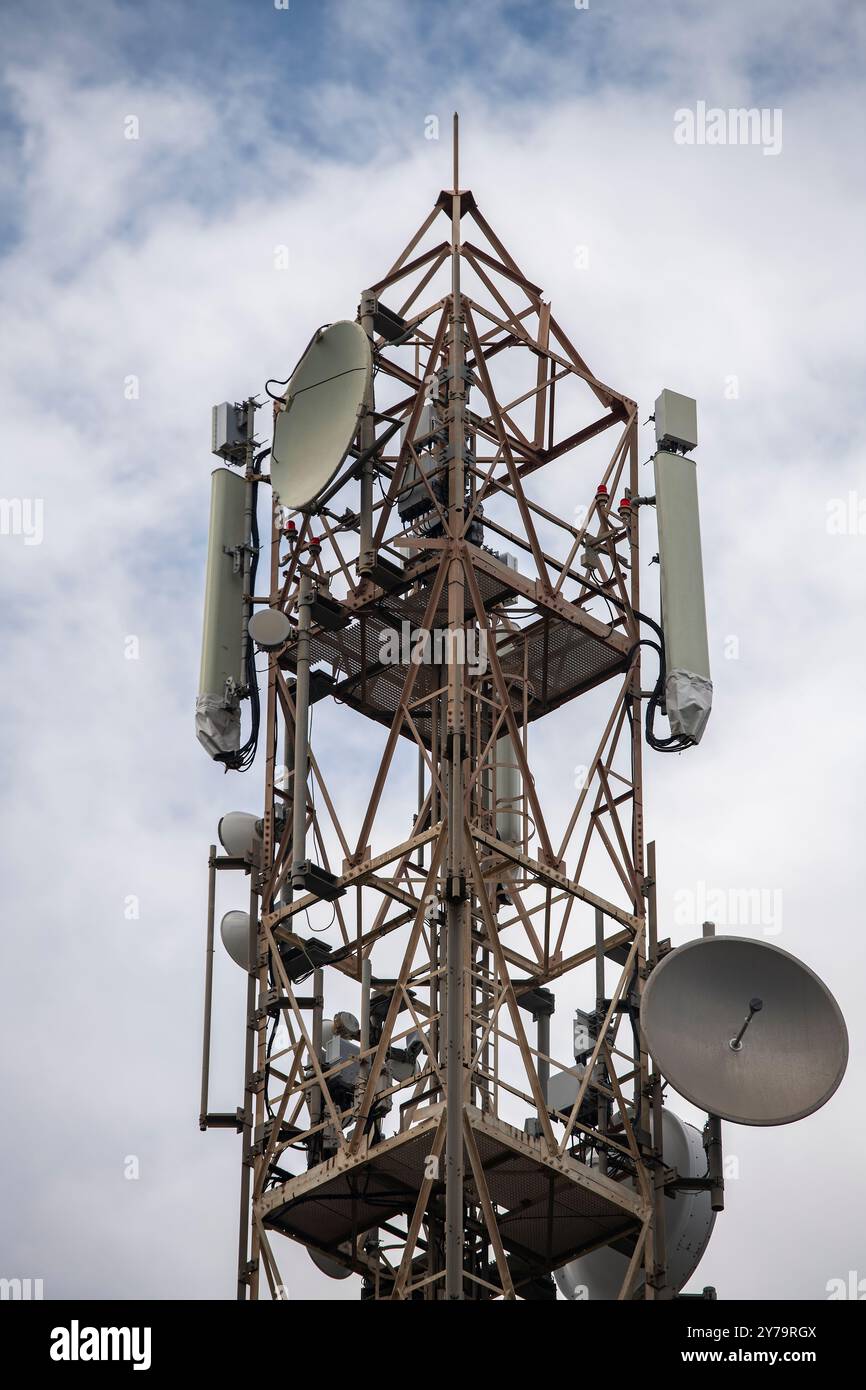 modern cellular mobile communications mast with receiving and transmitting antennas and ...
