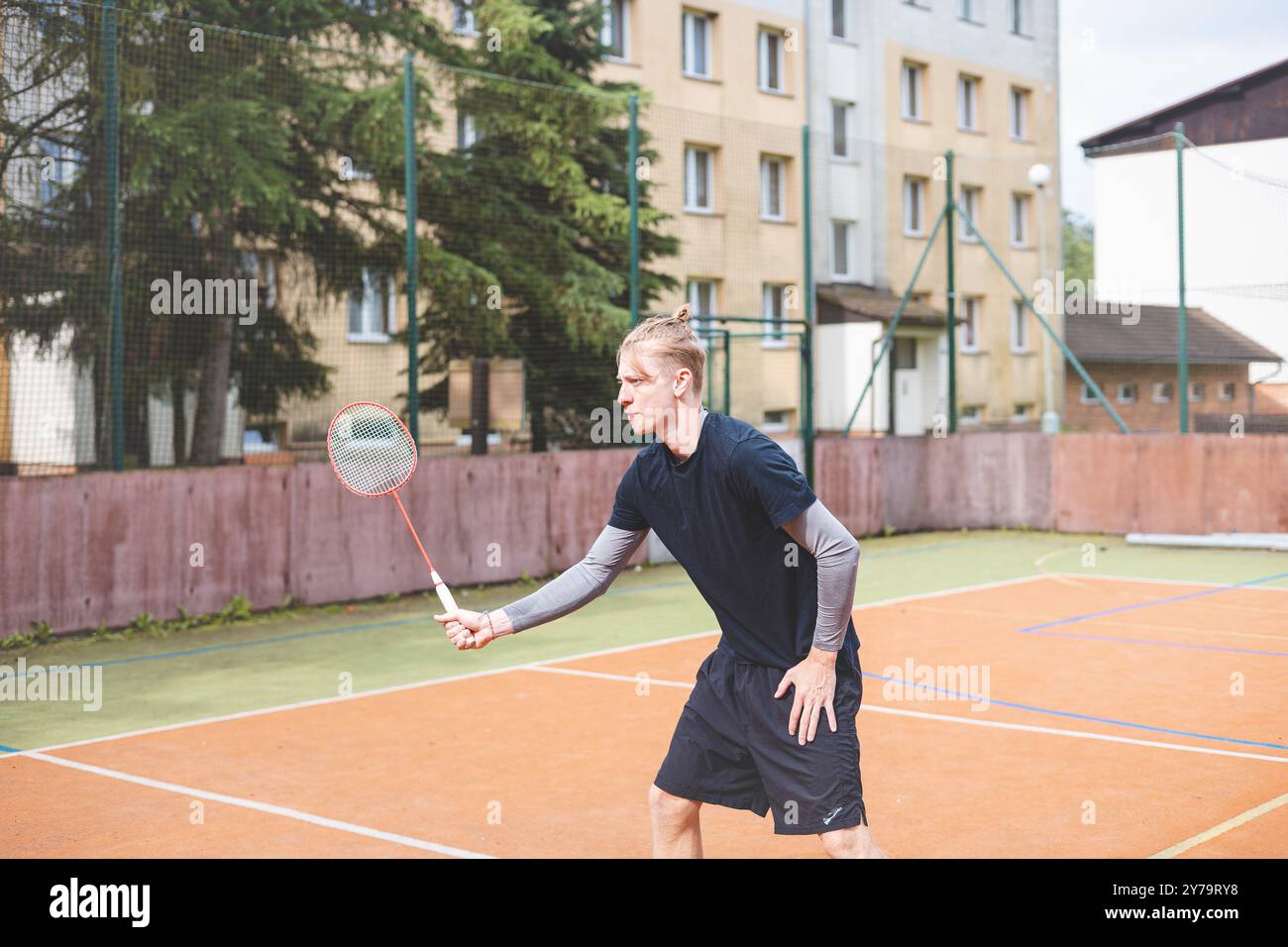 Badminton player focuses on the shuttlecock mid-air during a match on ...