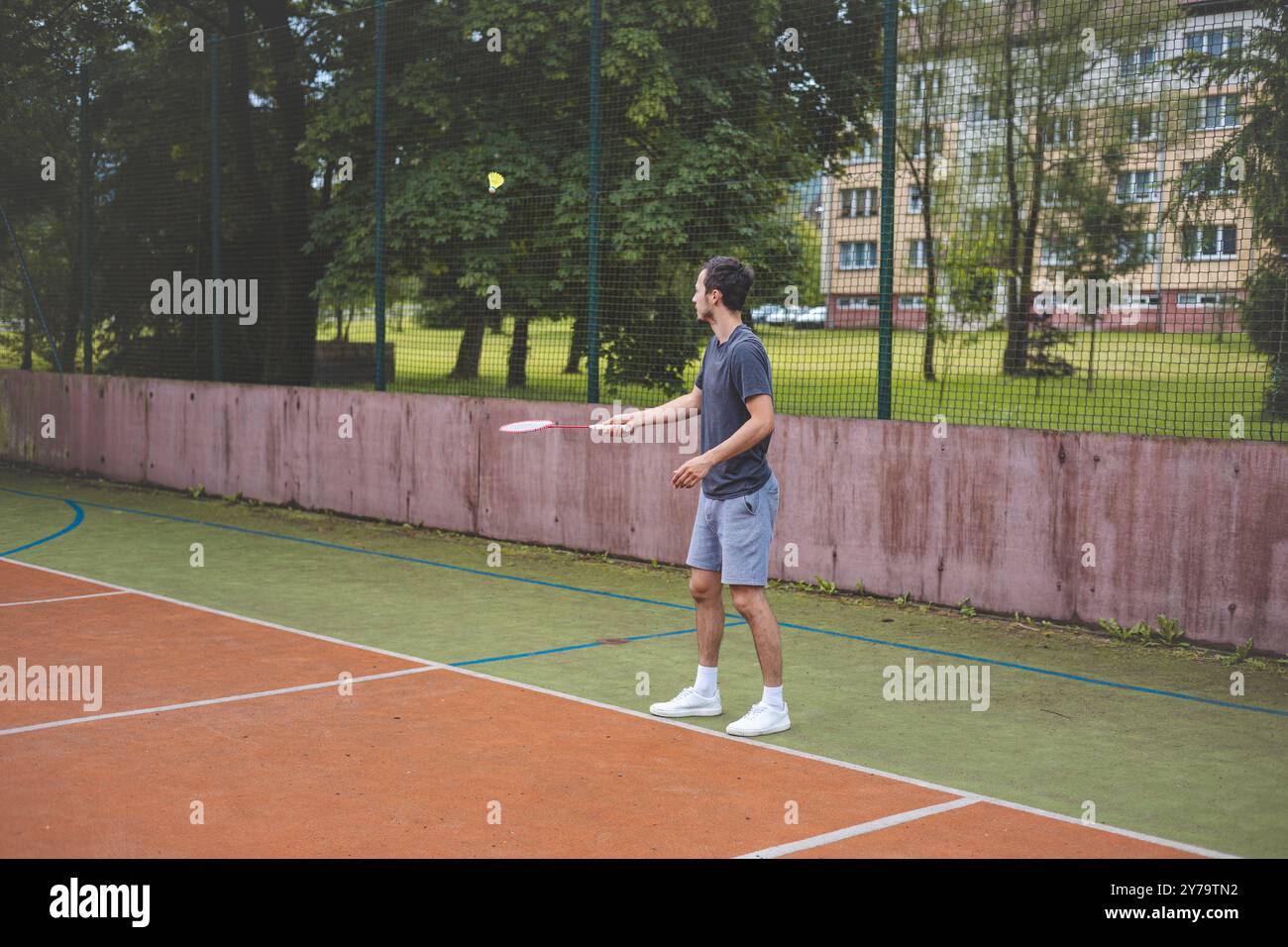 Badminton player focuses on the shuttlecock mid-air during a match on ...