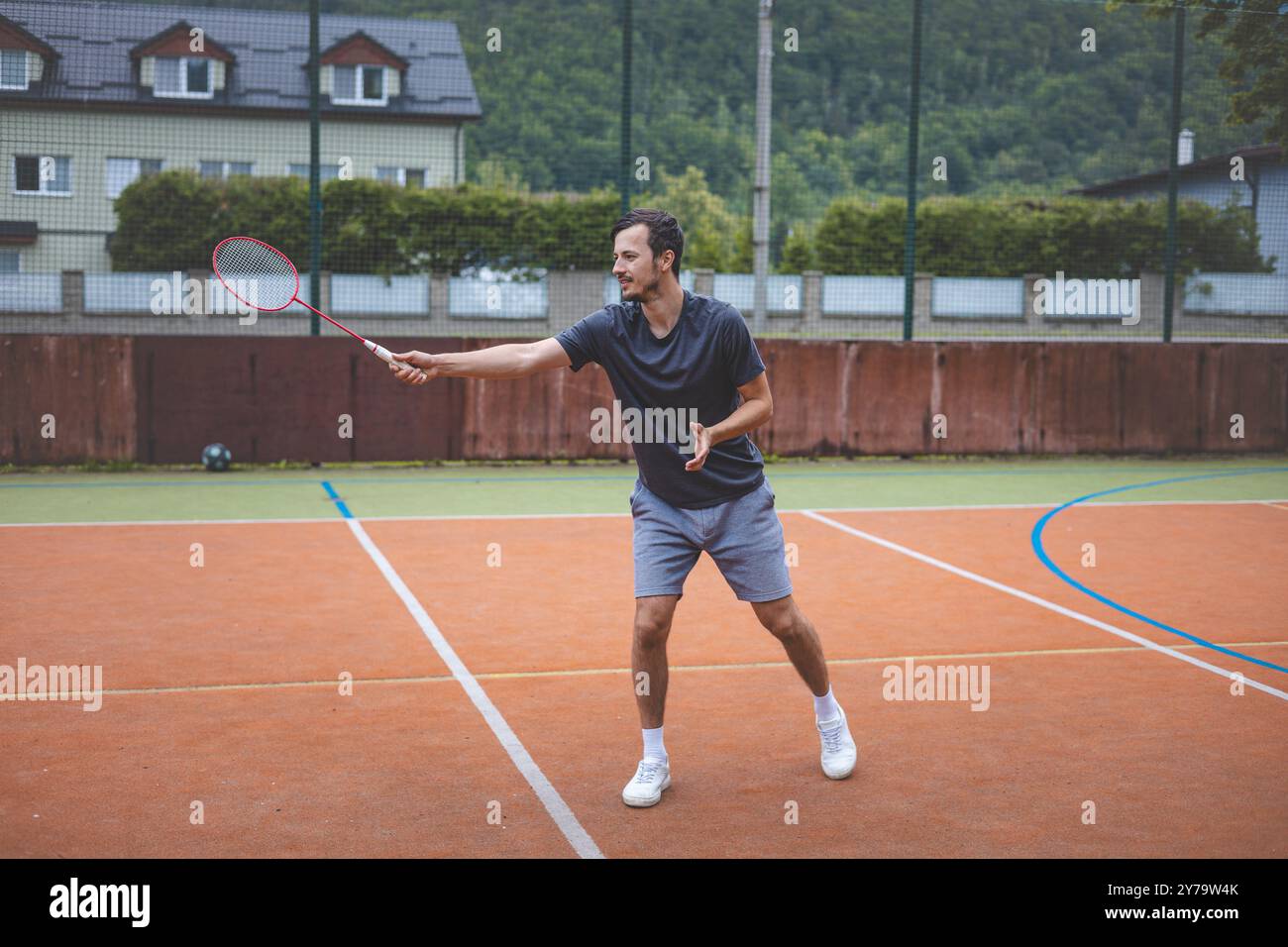 Badminton player focuses on the shuttlecock mid-air during a match on ...