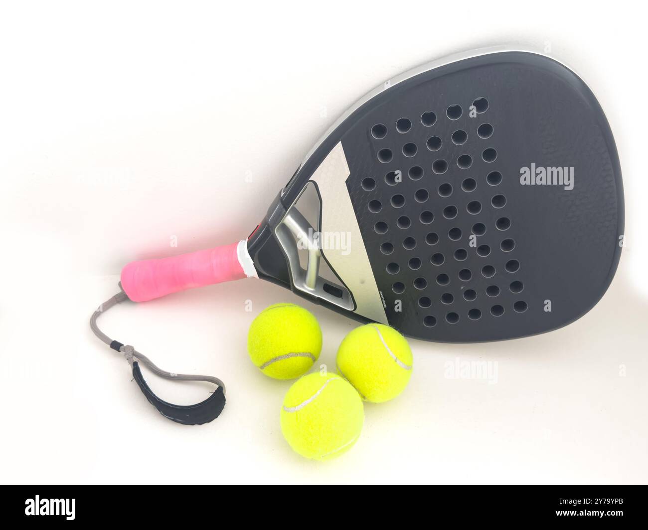 Padel racket and ball reflected on white table and white isolated ...
