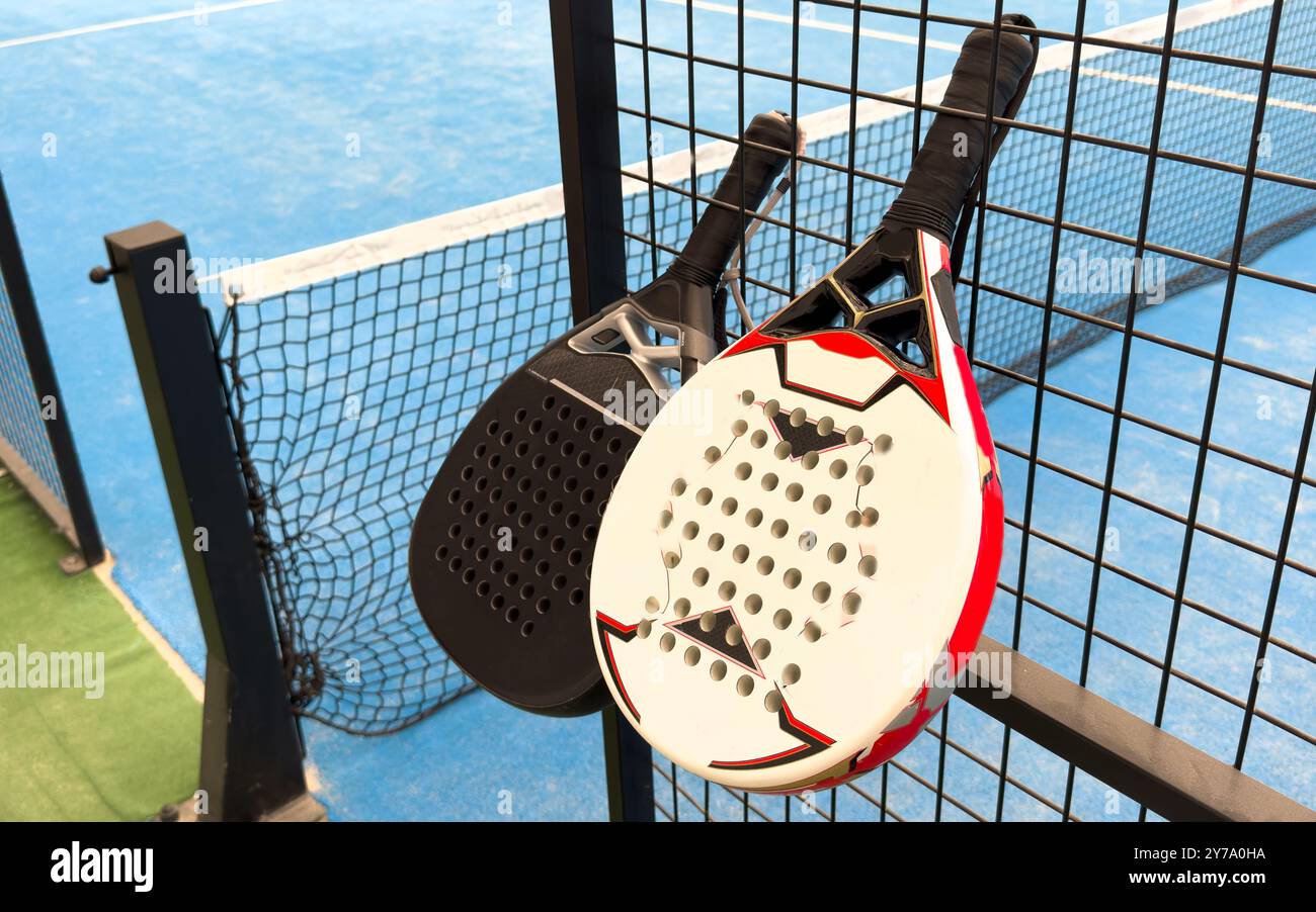 Paddle tennis: Paddel racket and ball in front of an outdoor court ...
