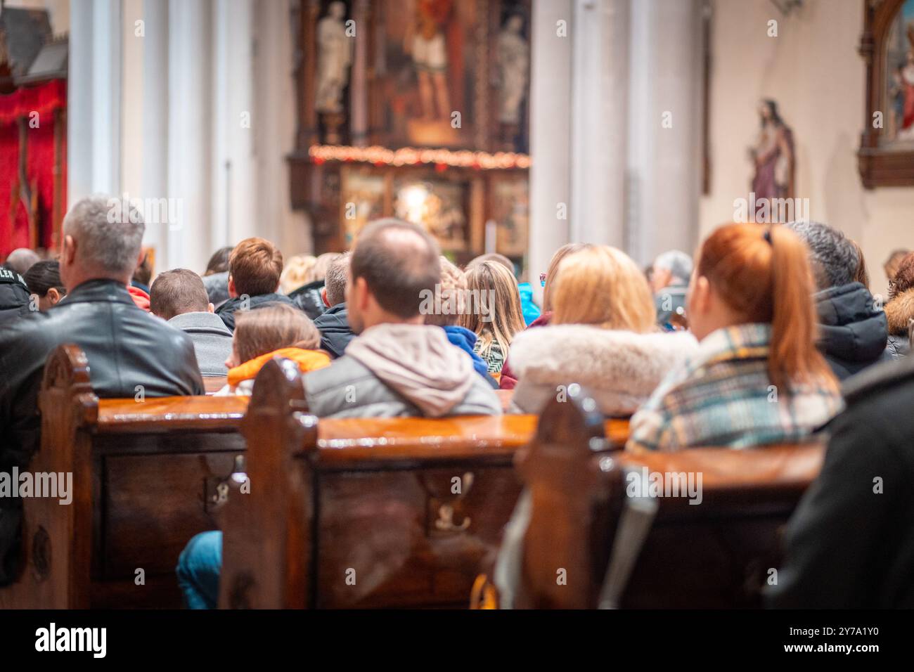 Back view of sitting parishioners. The Catholic Orthodox Christmas ...