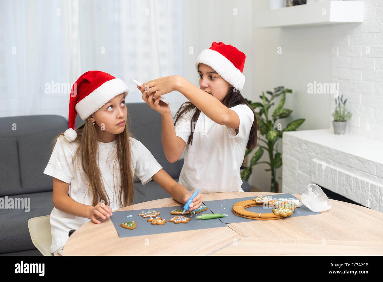 girls making Christmas cookies with cookie cutter. Child playing with ...