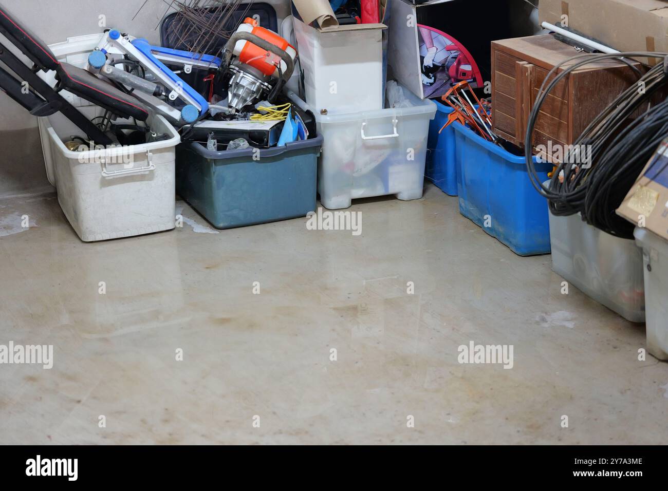 Water spreading. Flooding on storage room concrete floor in a house ...