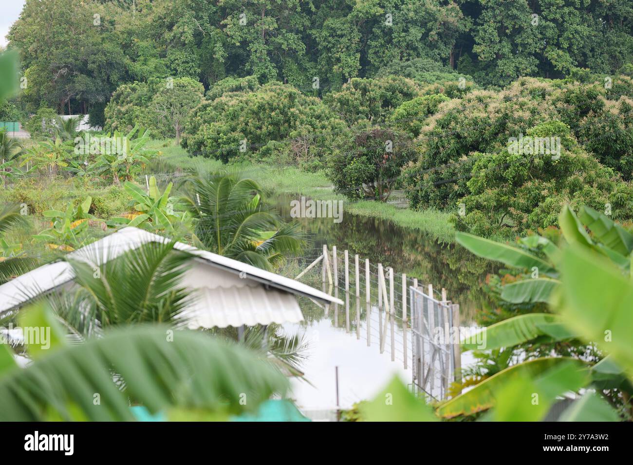 Deep floodwater on rural road looks like a river, with sitting water ...