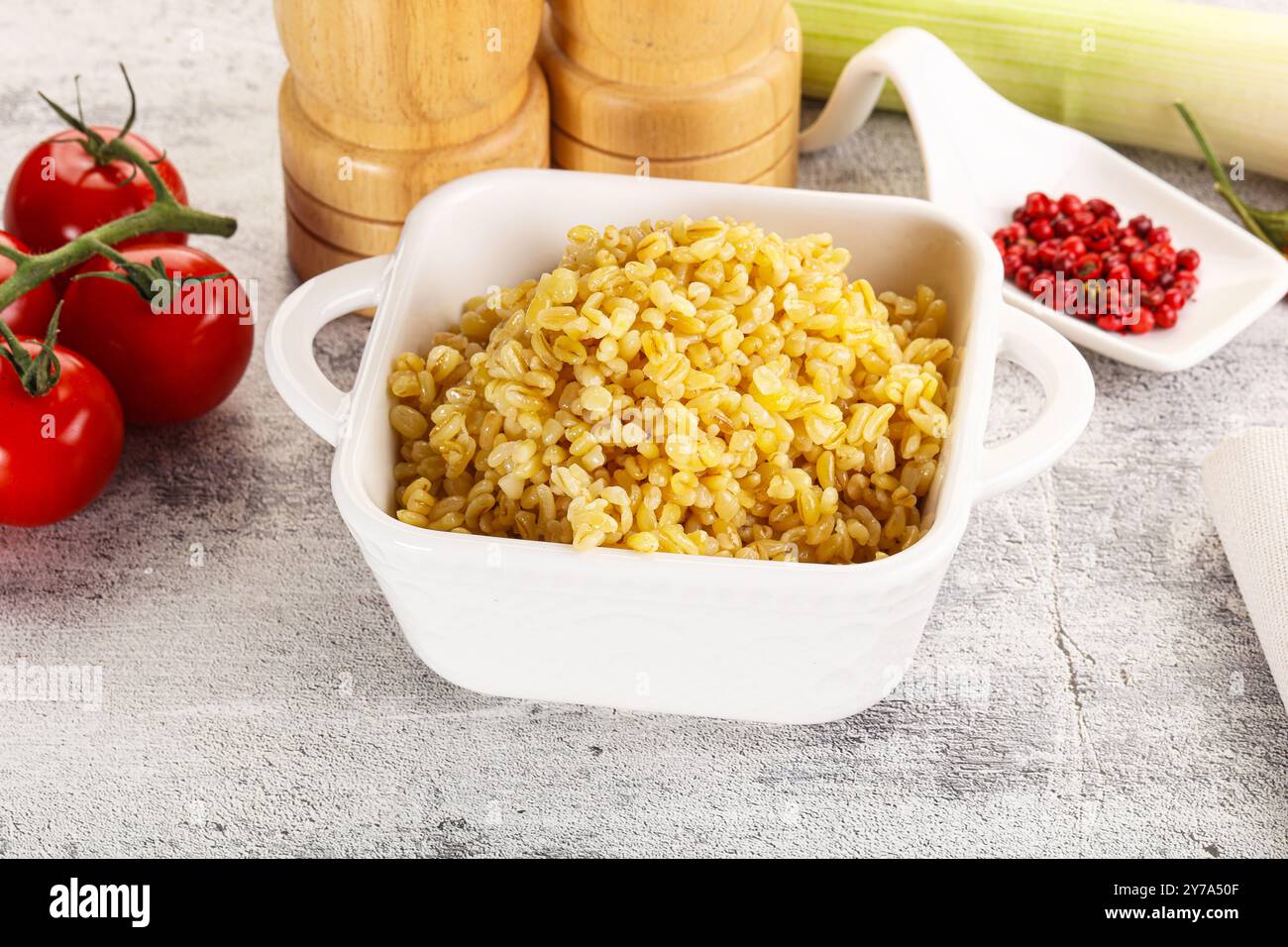 Boiled bulgur wheat in the bowl garnish Stock Photo - Alamy