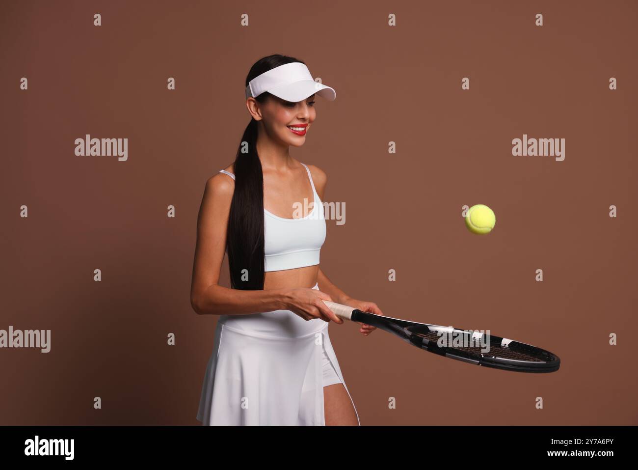 Happy tennis player with racket and ball on brown background Stock ...