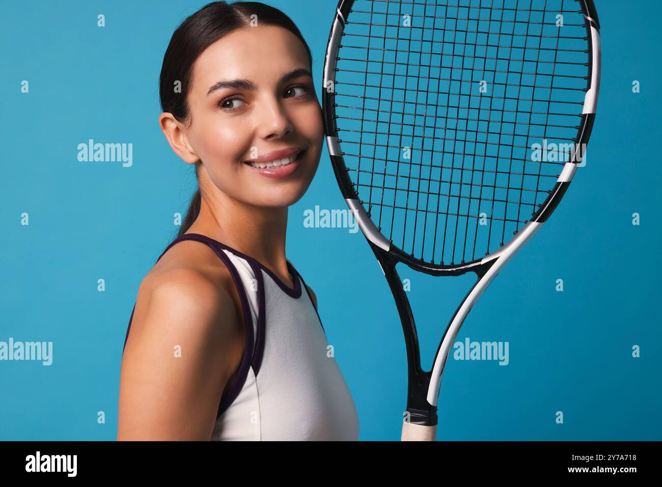 Beautiful young woman with tennis racket on light blue background Stock ...