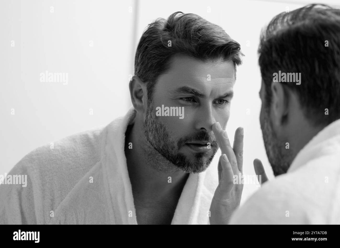 Beauty face portrait of a beautiful man applying face cream ...