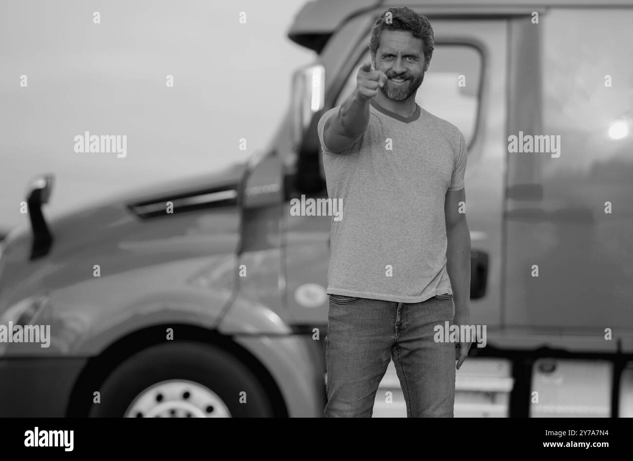 Men driver near lorry truck. Truck driver in safety vest near truck ...