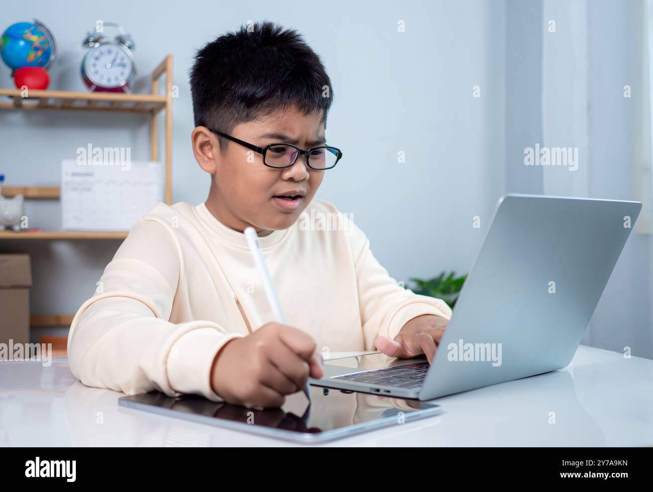 Little Asian boy student using computer laptop learning. Educational of ...