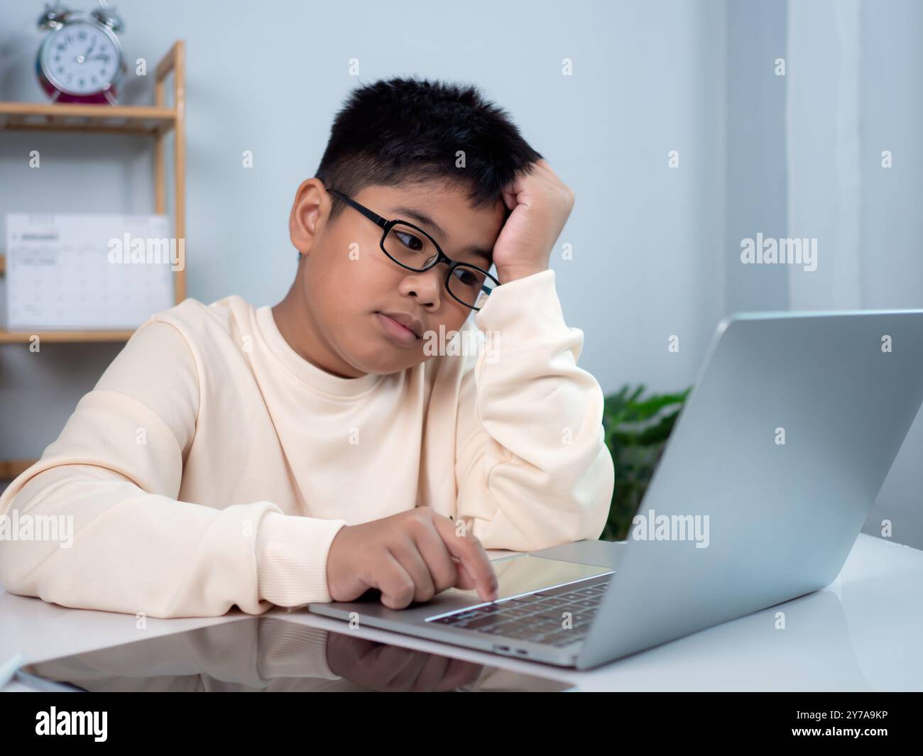 Boy using computer for learning and stressed about online learning ...
