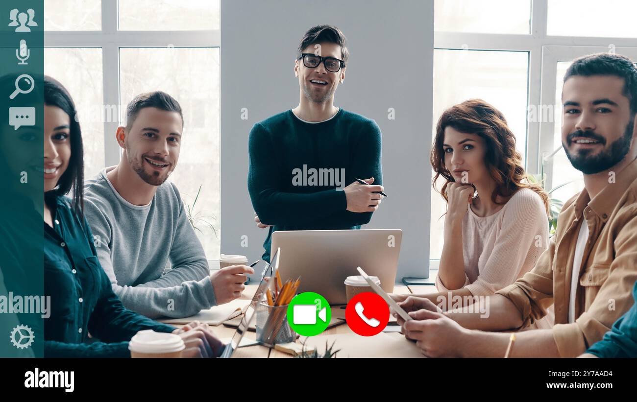 Group of coworkers smiling and communicating together while conducting ...