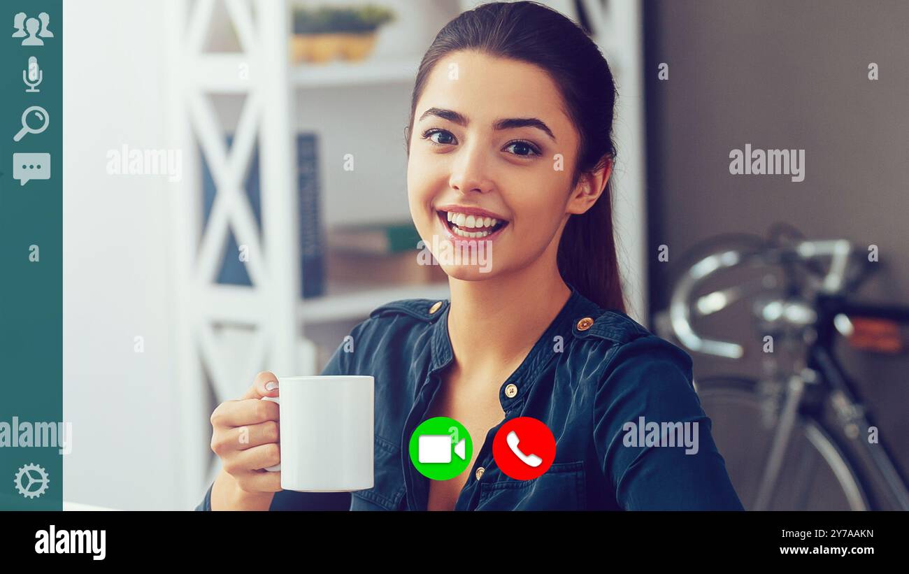 Self portrait of attractive young woman smiling and drinking tea while ...