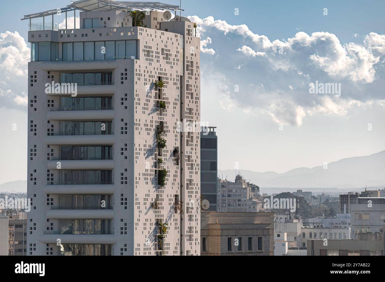 Modern white building towering over cityscape of Nicosia with Troodos ...