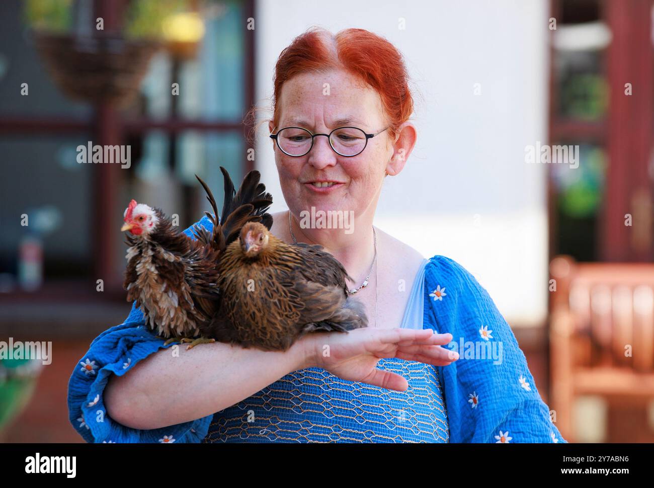 Animal whisper Catherine Hoy holding two hens during a pet therapy ...