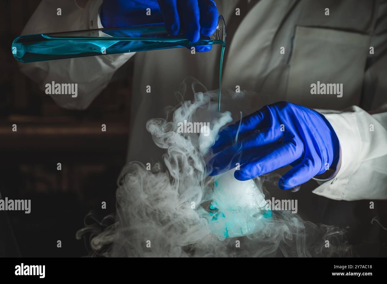 A woman scientist performing Organic reaction under fuming condition in ...