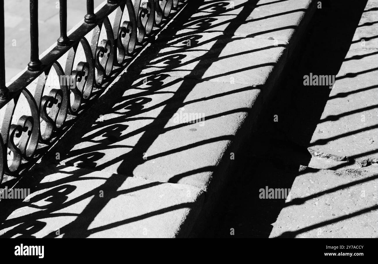 Iron railing and its shadow on flagstones abstract background Stock ...