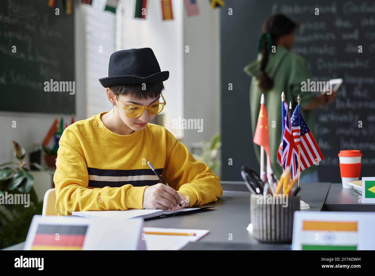 Female Student Taking Notes in School Classroom Stock Photo - Alamy
