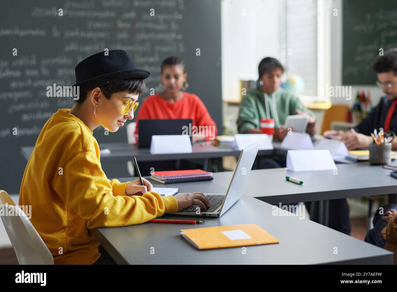Side View Teen Female Student using Computer during Lesson Stock Photo ...