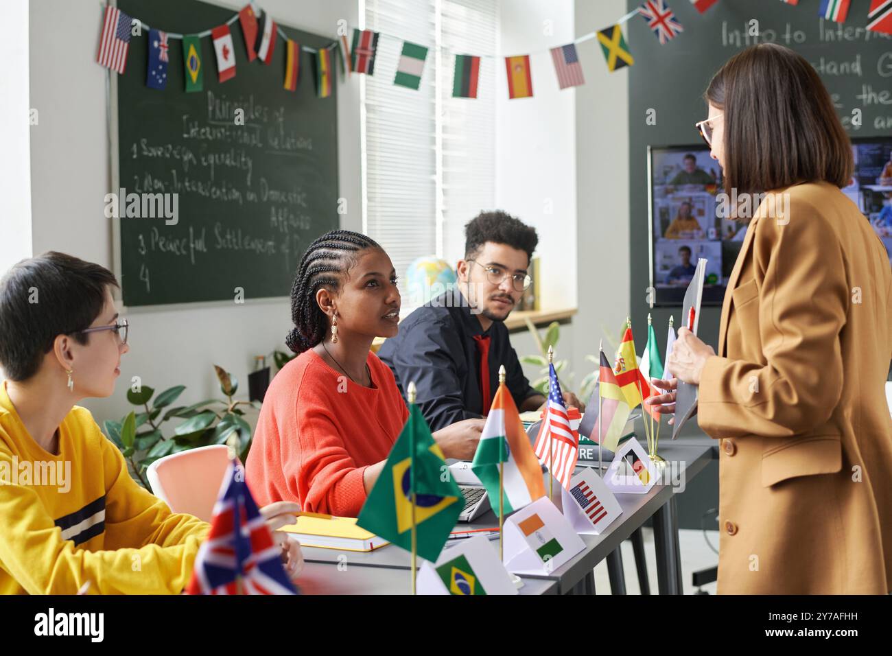 Female Teacher Talking to Students at School Stock Photo - Alamy