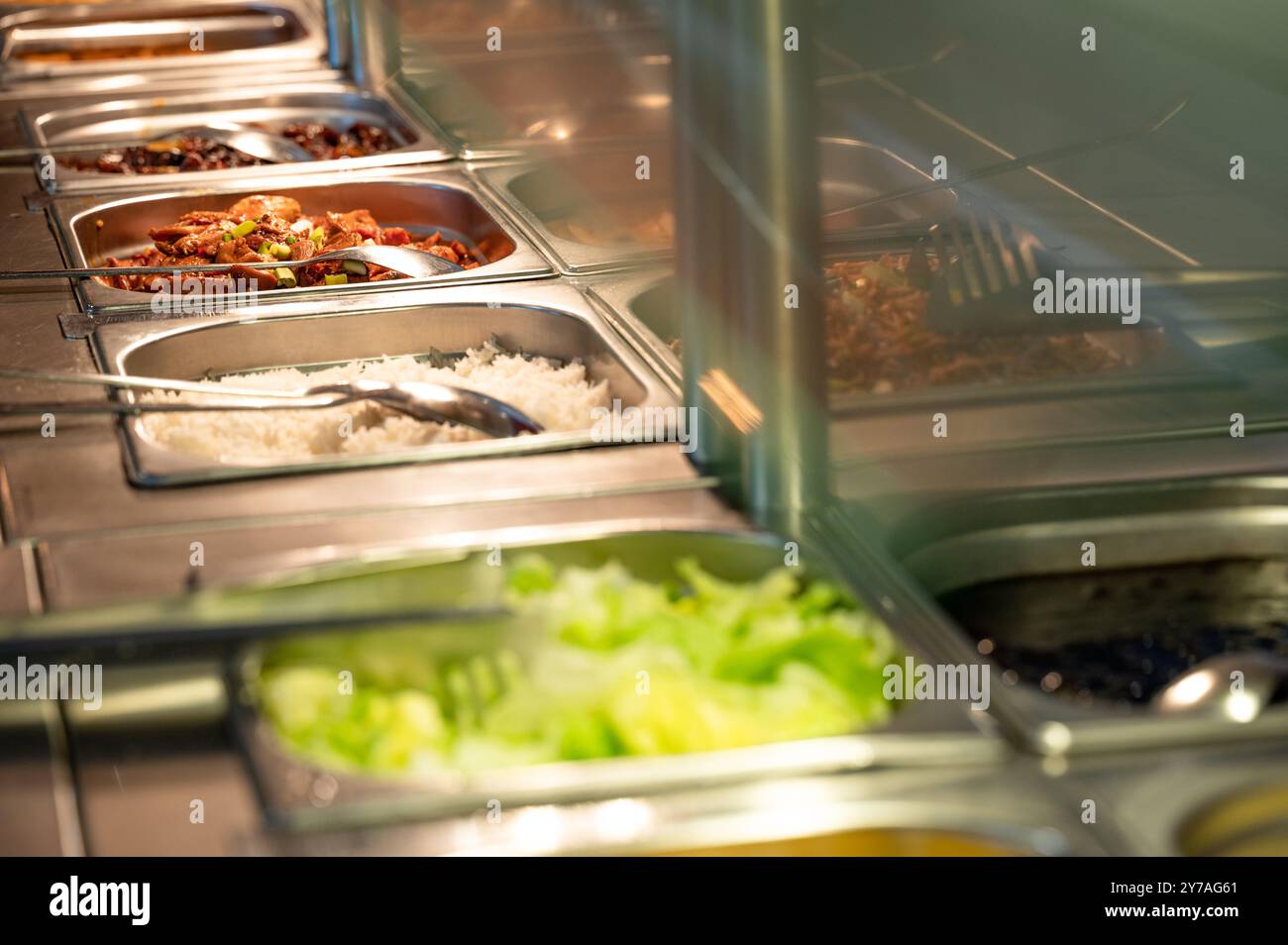 Asian food buffet in restaurant multiple food dishes and salad. Eat as ...