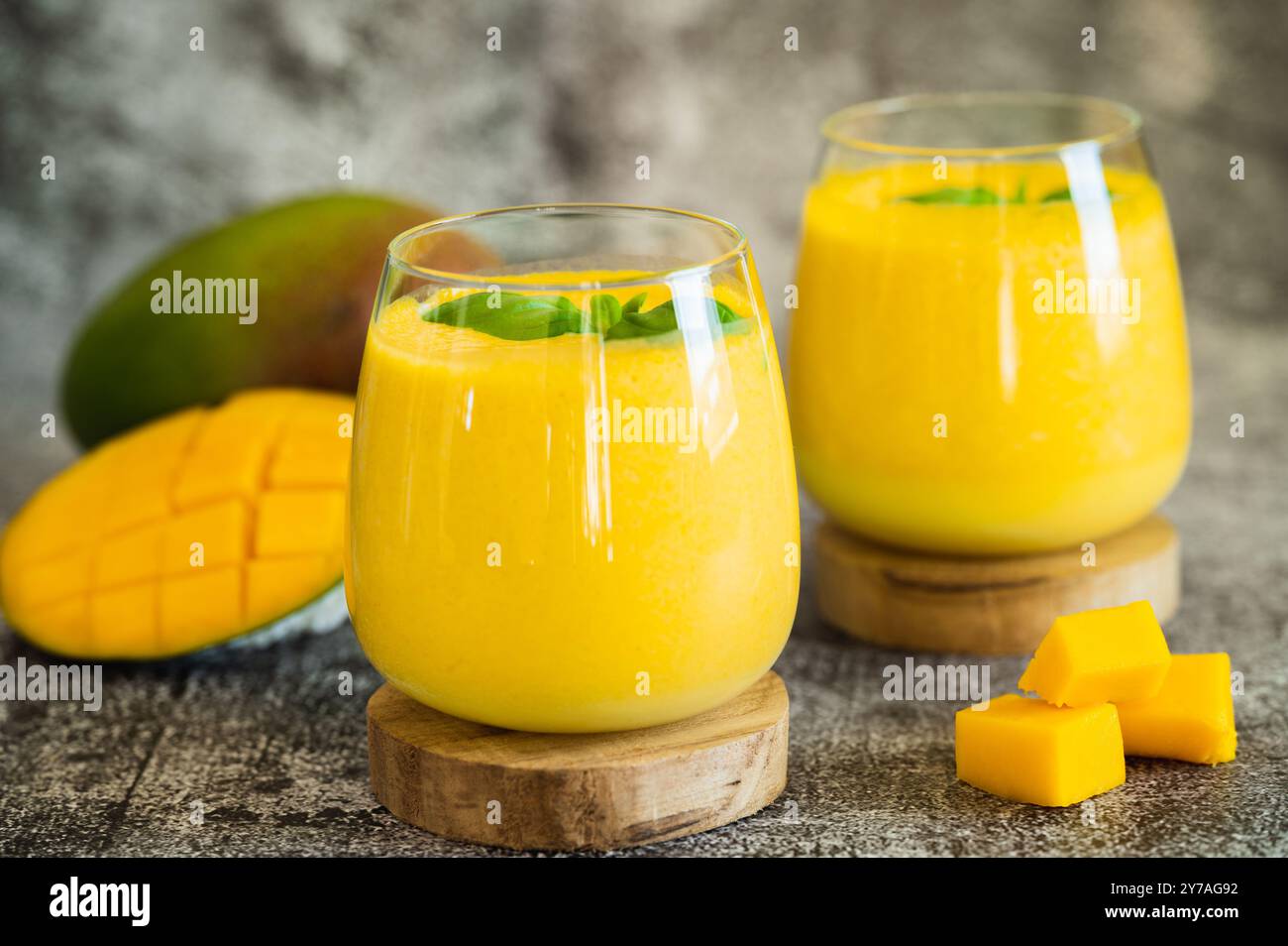 Fresh mango lassi in glasses on grey background with copy space. Indian ...