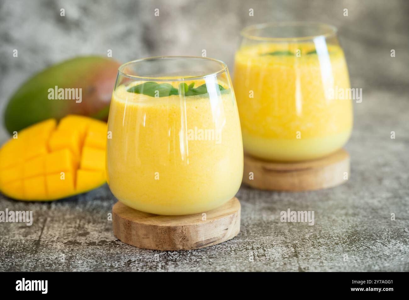 Fresh mango lassi in glasses on grey background with copy space. Indian ...