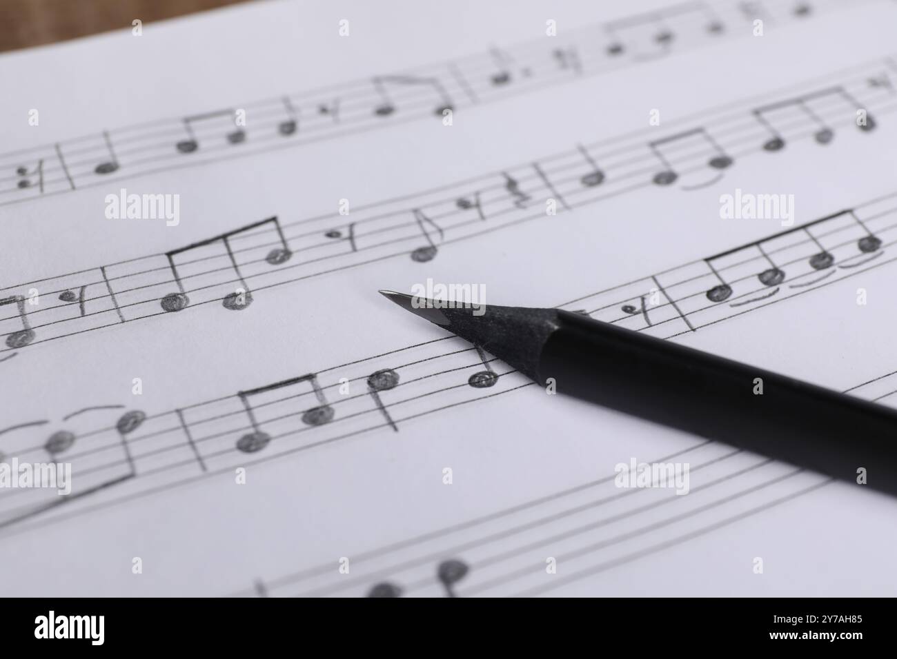 Sheet with musical notes and pencil, closeup view Stock Photo - Alamy